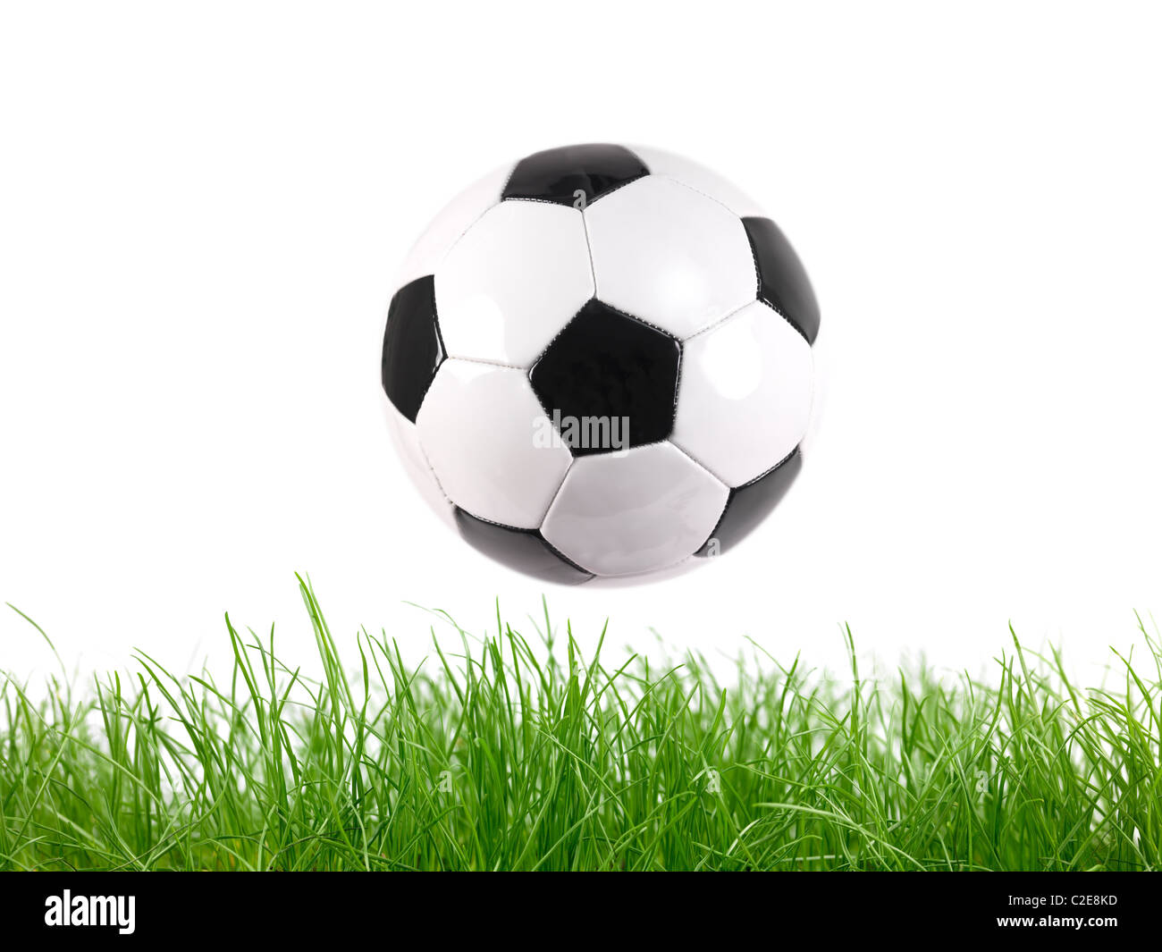 A soccer ball floating above green grass Stock Photo - Alamy