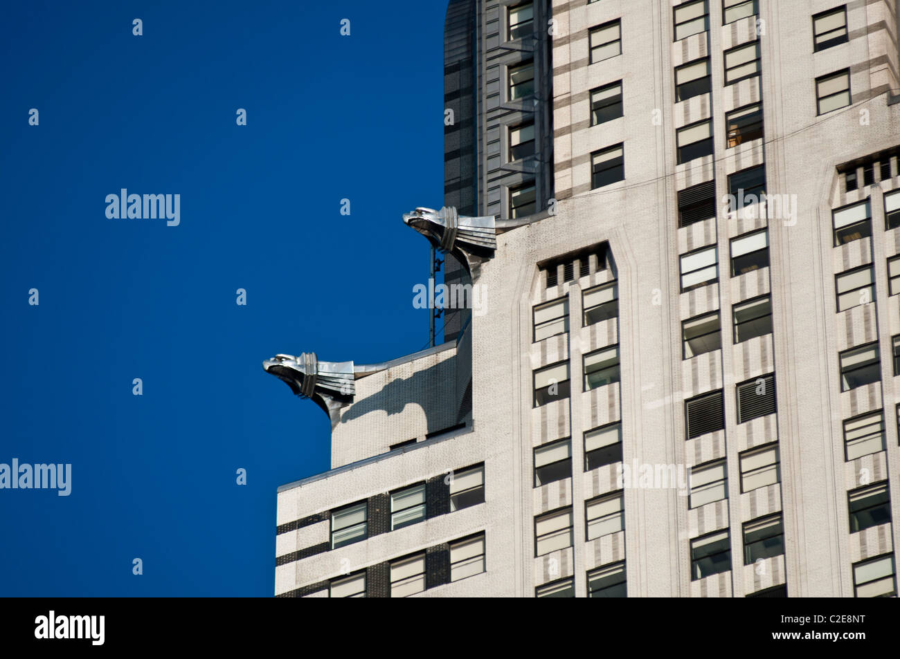Chrysler building steel spire with gargoyles, blue sky background ...