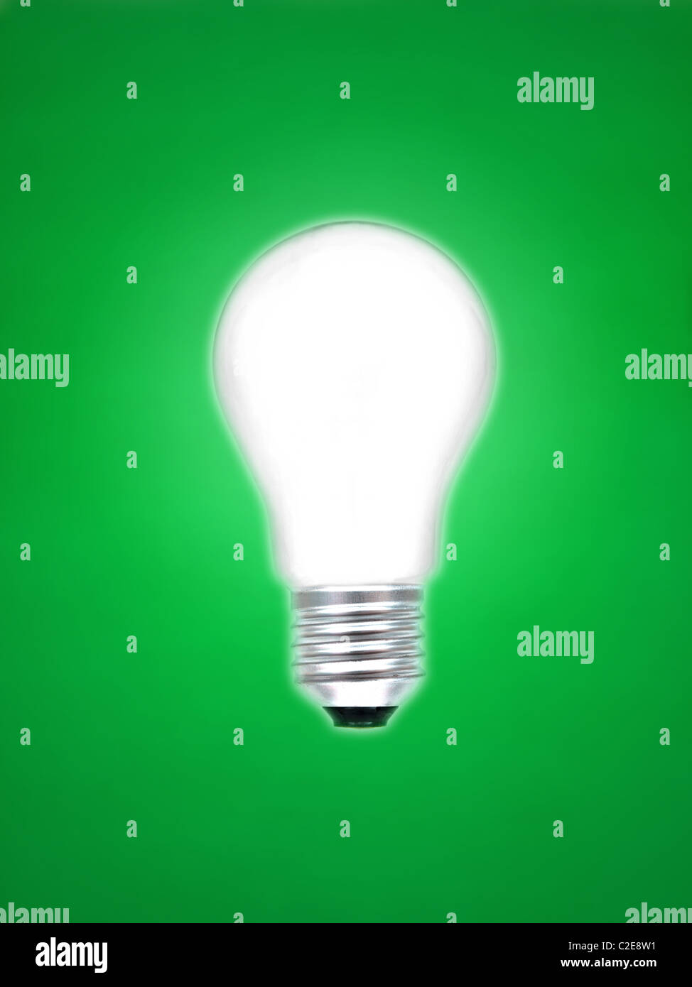 A light bulb isolated against a green background Stock Photo - Alamy