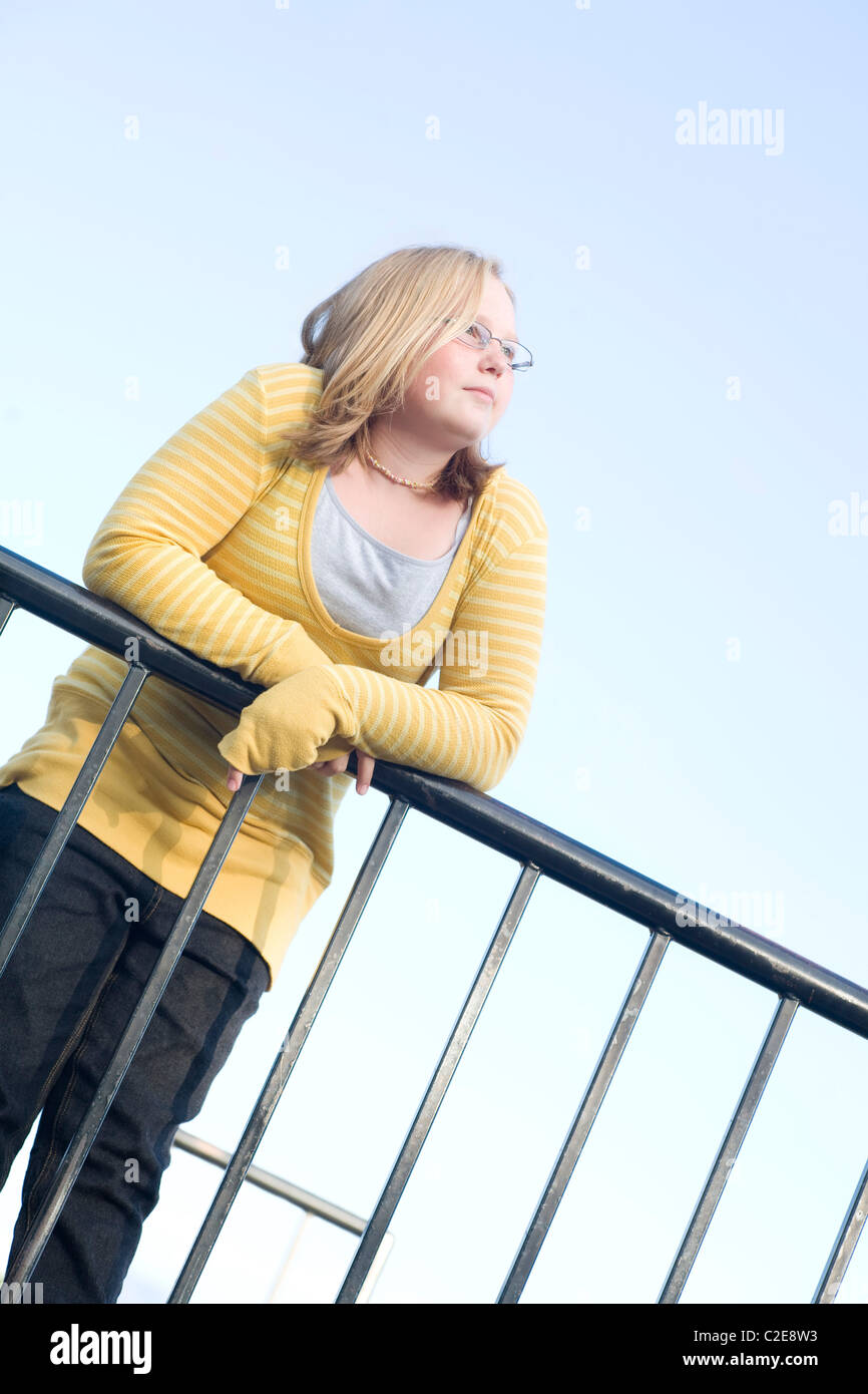Girl Leaning On Railing Stock Photo - Alamy