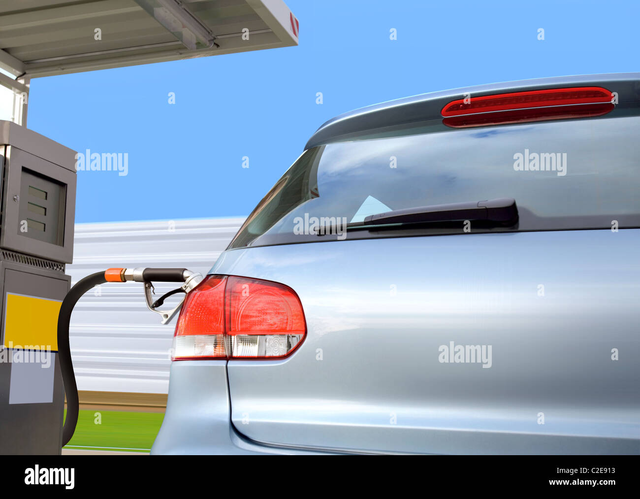 At the gas station pump putting gas into the car Stock Photo - Alamy