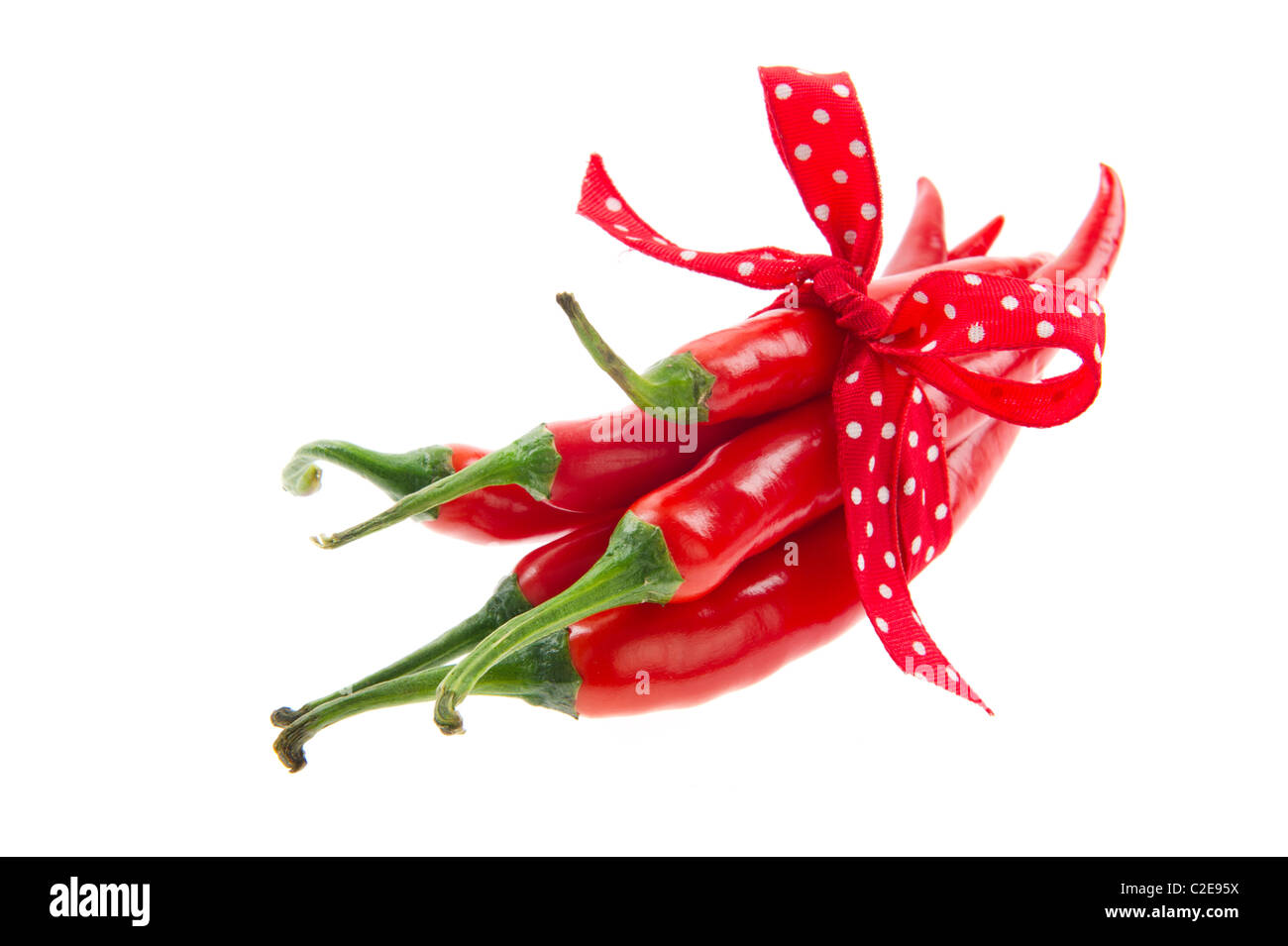 Fresh red hot chili peppers tied with ribbon isolated over white Stock ...