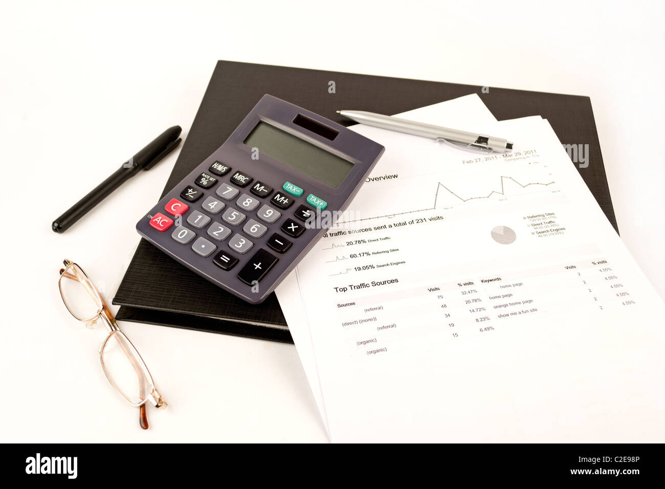 with calculator, charts, pen, glasses Stock Photo - Alamy