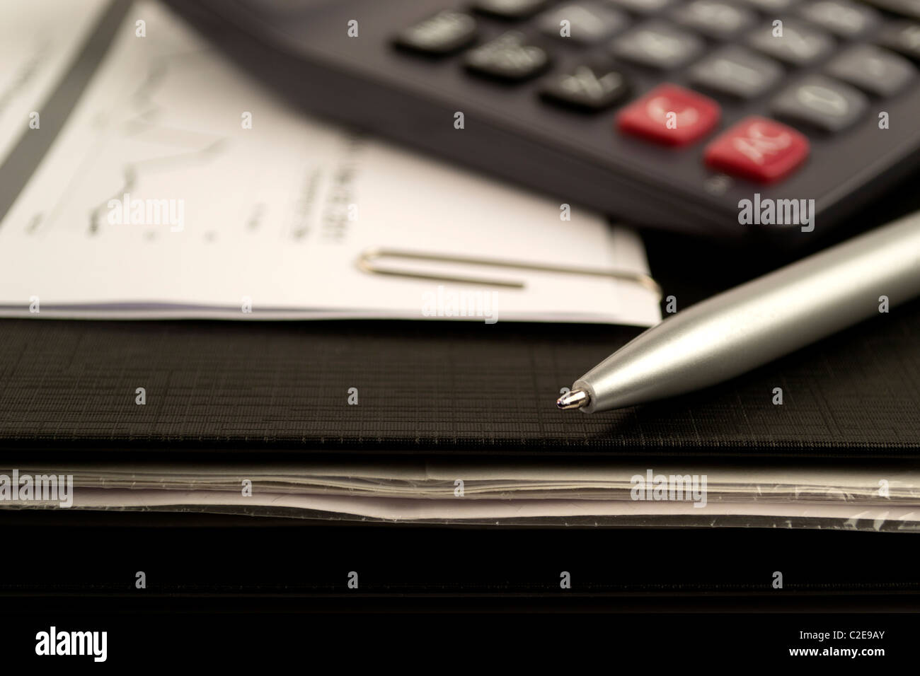 Paperwork concept with charts, calculator, pen Stock Photo - Alamy