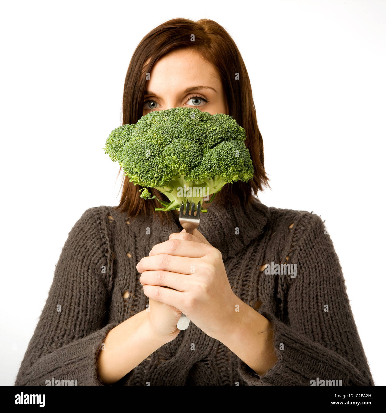 A woman ready to eat broccoli Stock Photo - Alamy