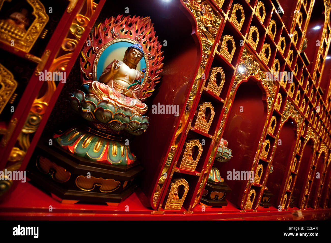 An interior of a buddhist temple with many Buddha statues Stock Photo ...