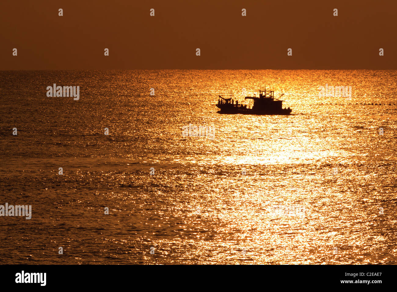 The rising sun illuminates a fishing boat at the set-net fishing ground ...