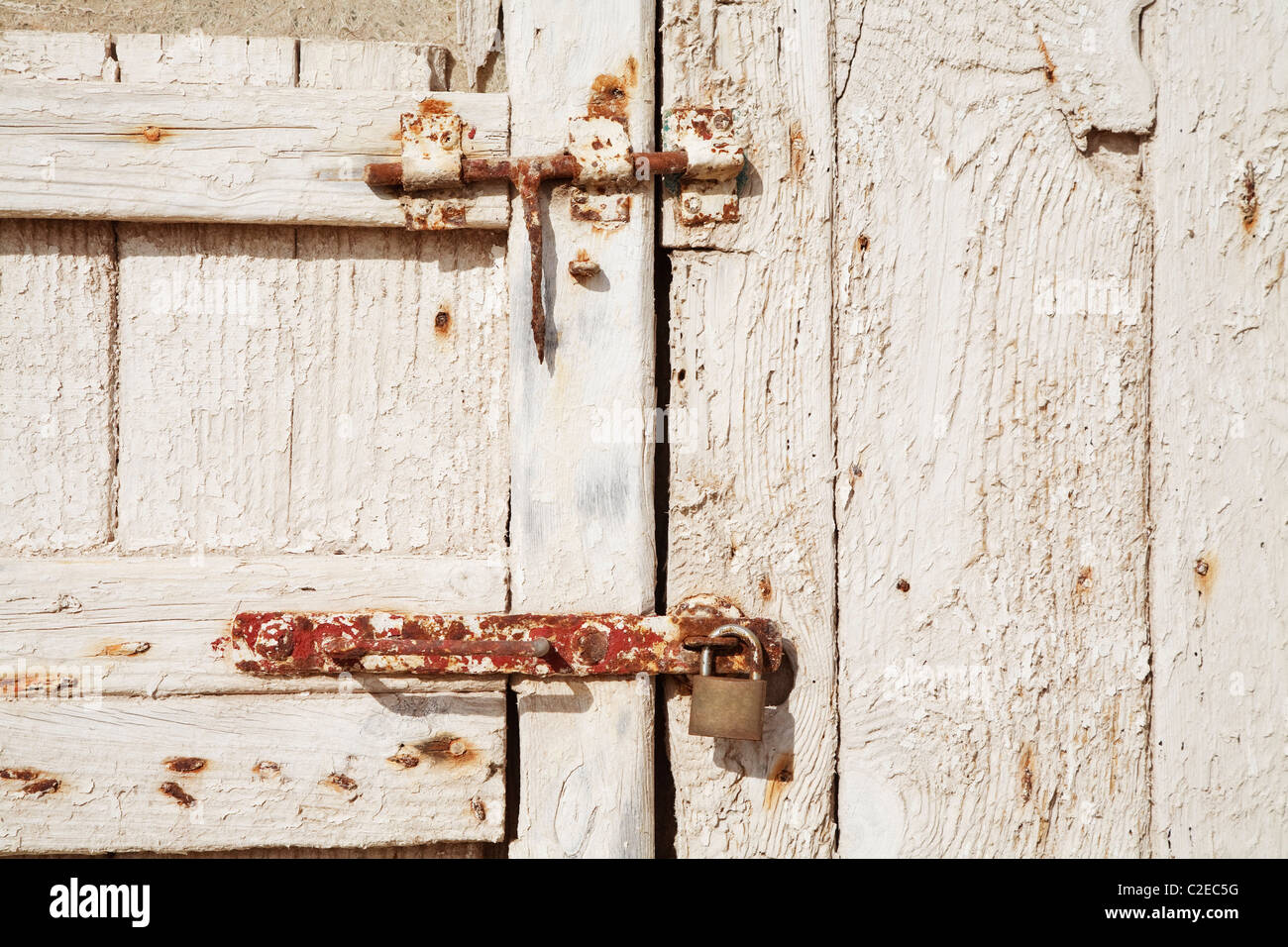 Rusted Lock And Bolt On A Weathered Wooden Door Stock Photo - Alamy