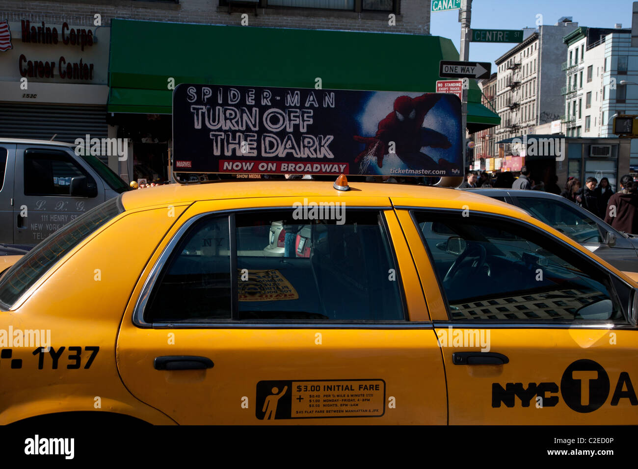 A yellow taxi cab with an advertising billboard for the Broadway ...