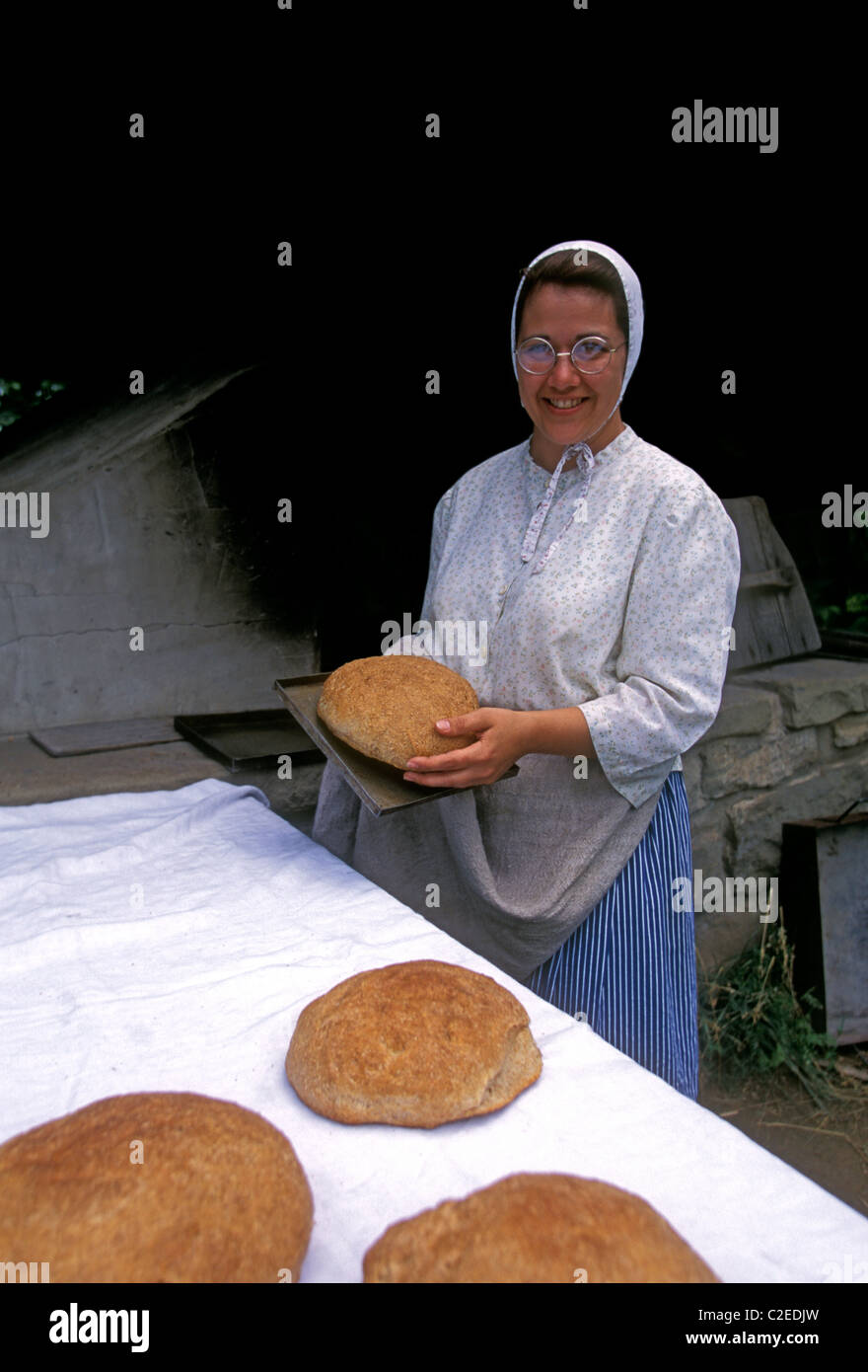 1, one, Canadian woman wearing period costume, baking bread, Acadian ...