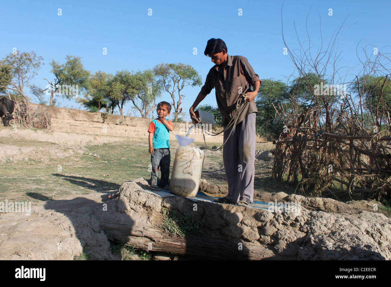 A person collecting water from well during summer in Gujarat, india ...