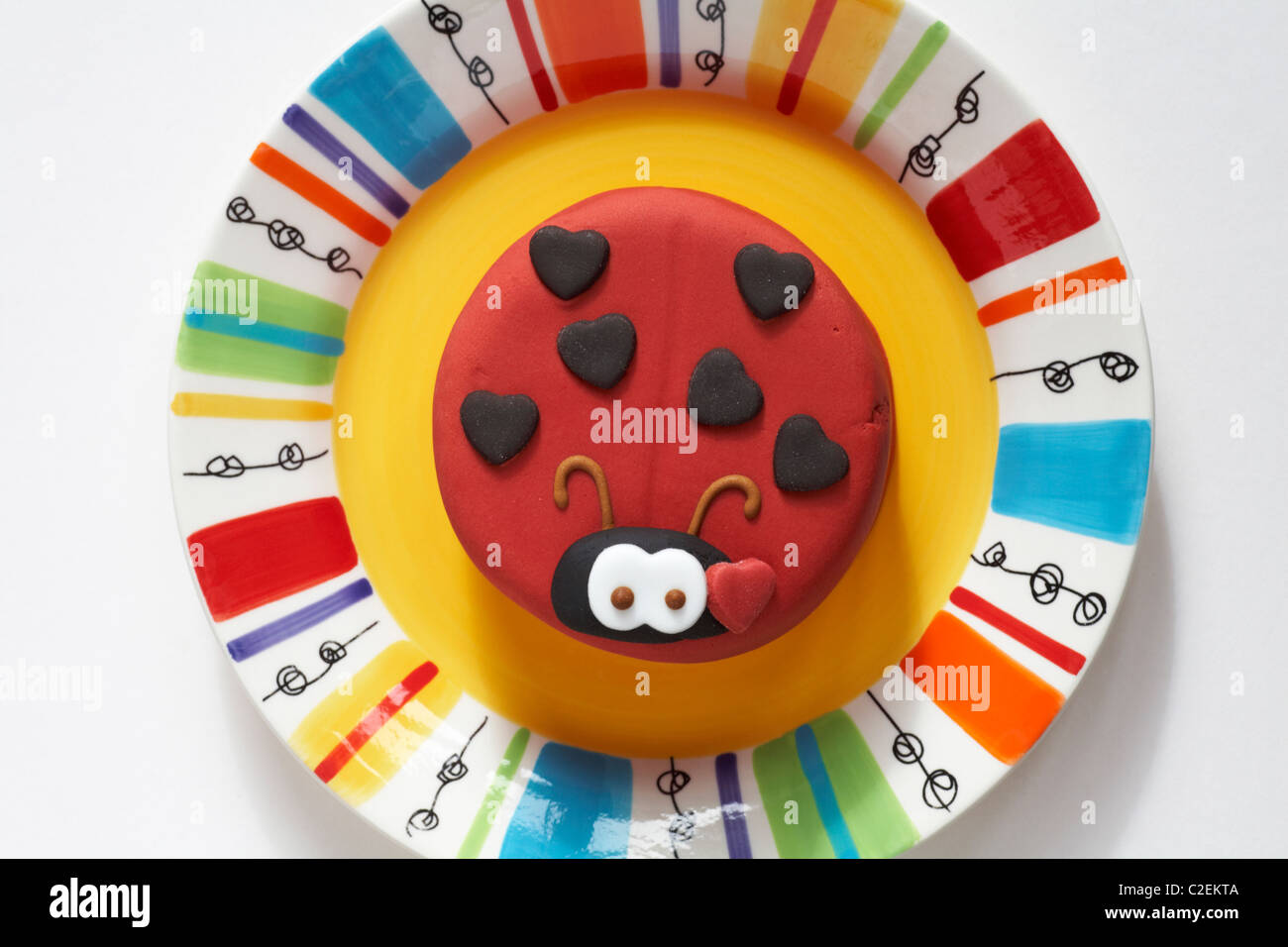 marzipan cake in shape of a ladybird lady bird placed on colourful ...