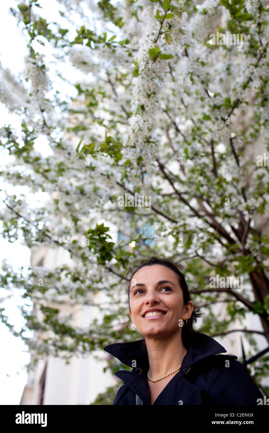 Latin woman under a tree with blossoms in spring Stock Photo - Alamy