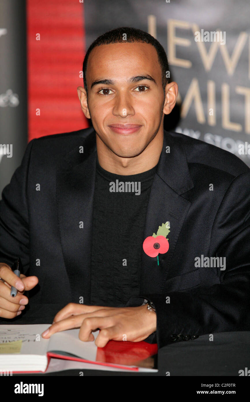 Formula One driver Lewis Hamilton signs copies of his new autobiography ...