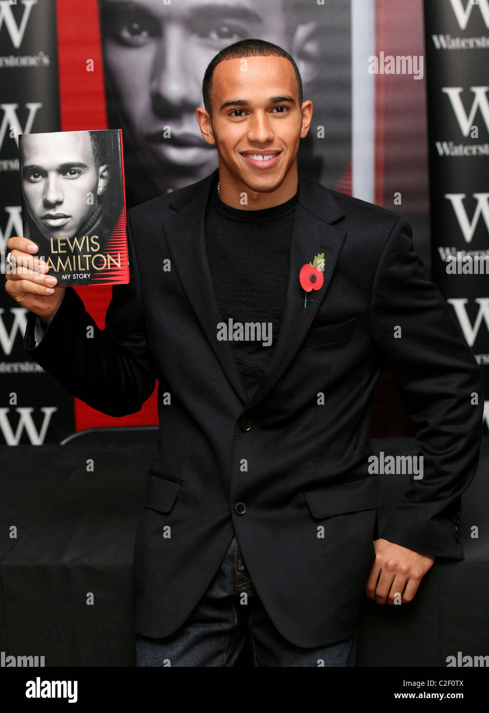 Formula One driver Lewis Hamilton signs copies of his new autobiography ...