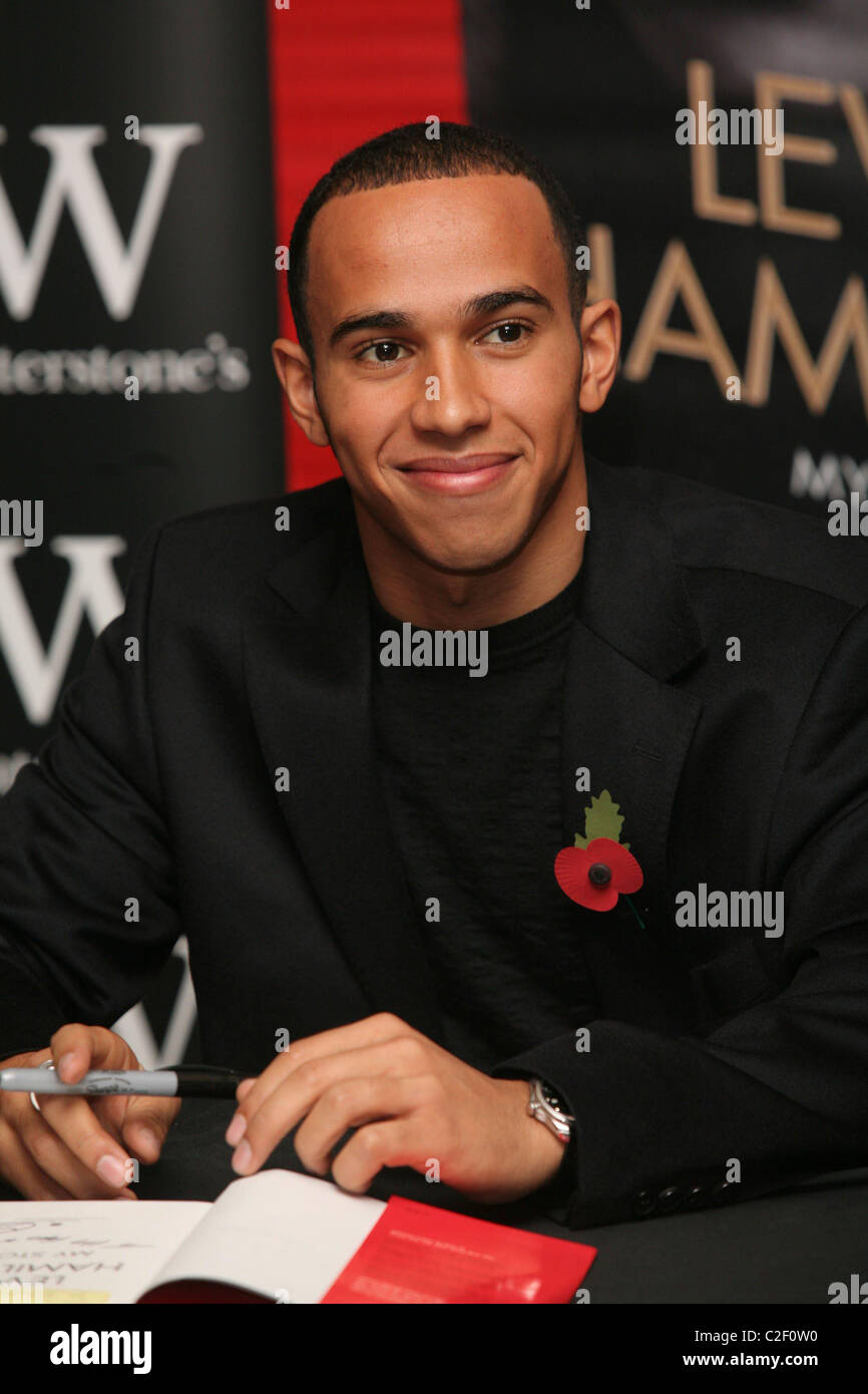Formula One driver Lewis Hamilton signs copies of his new autobiography ...