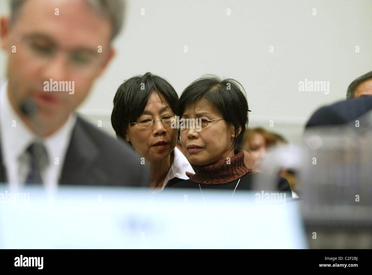 Yu Lin and Gao Gin Sheng listening to Yahoo executives speak to the ...