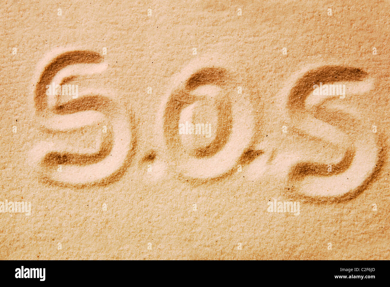S.O.S. written in golden sand - distress message Stock Photo - Alamy