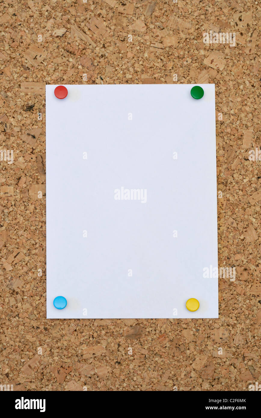 paper pinned on corkboard with pins of different colour Stock Photo - Alamy