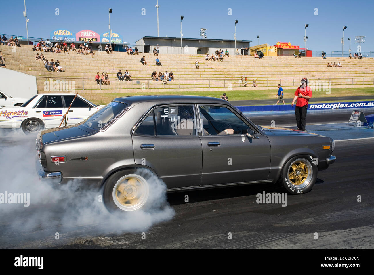 Mazda rotary engined RX3 car performing a burnout at an Australian drag ...