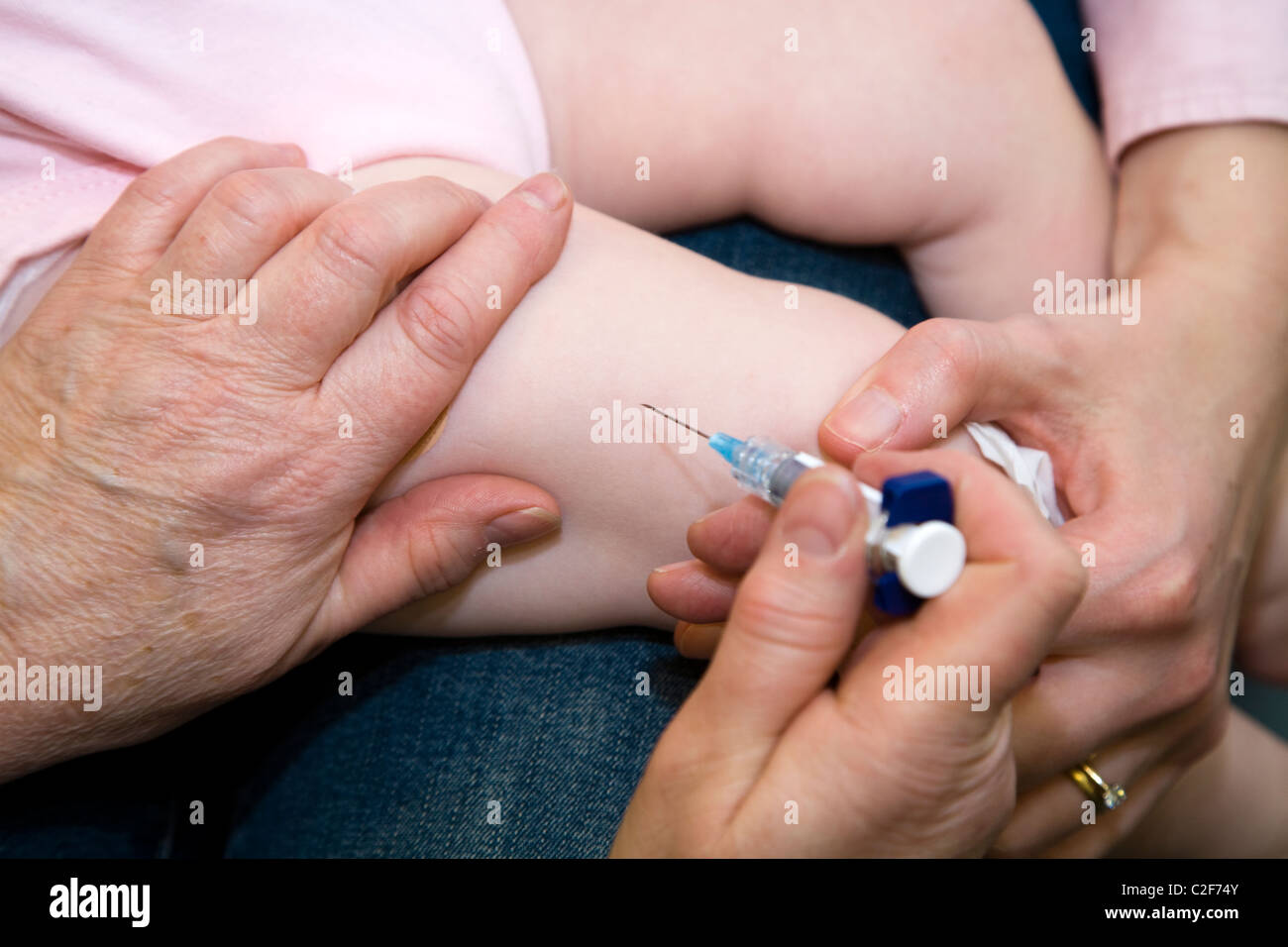 MMR etc immunisation / inoculation / jab / from a syringe into a one ...