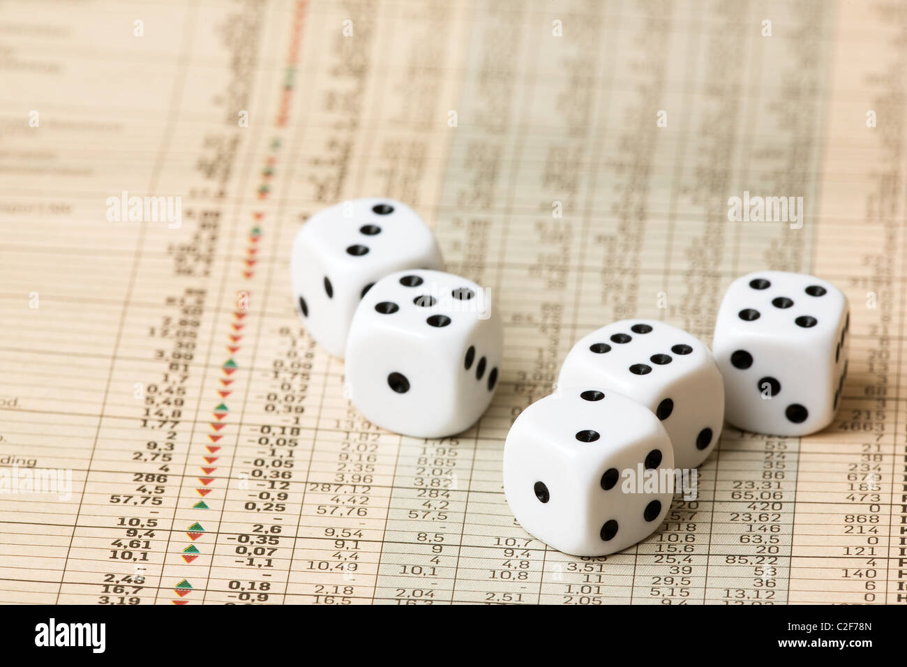 Dice and stock market charts in the newspaper Stock Photo - Alamy