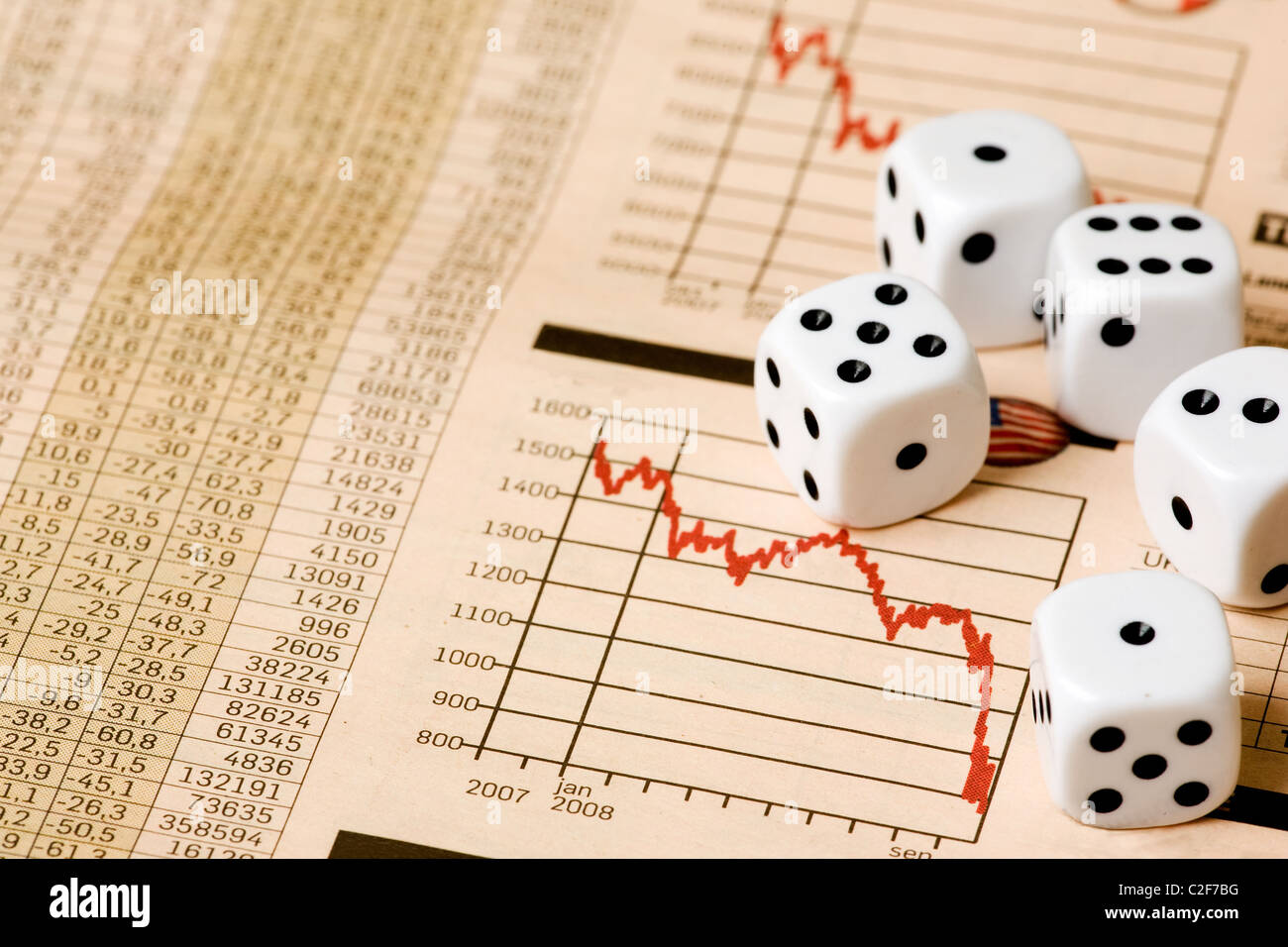 Dice and stock market charts in the newspaper Stock Photo - Alamy