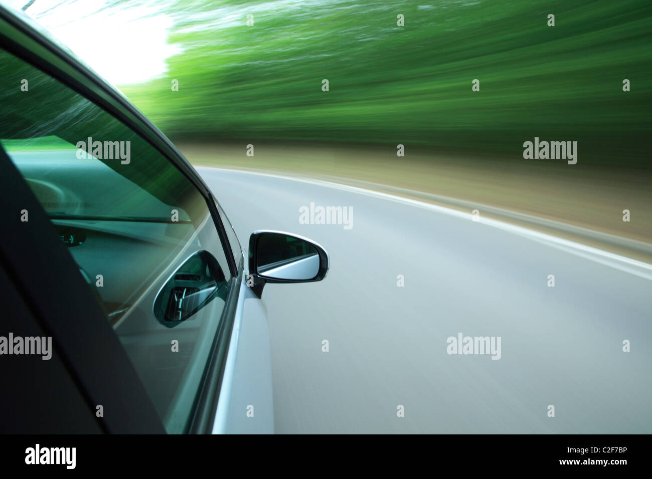 car driving fast into forest Stock Photo - Alamy