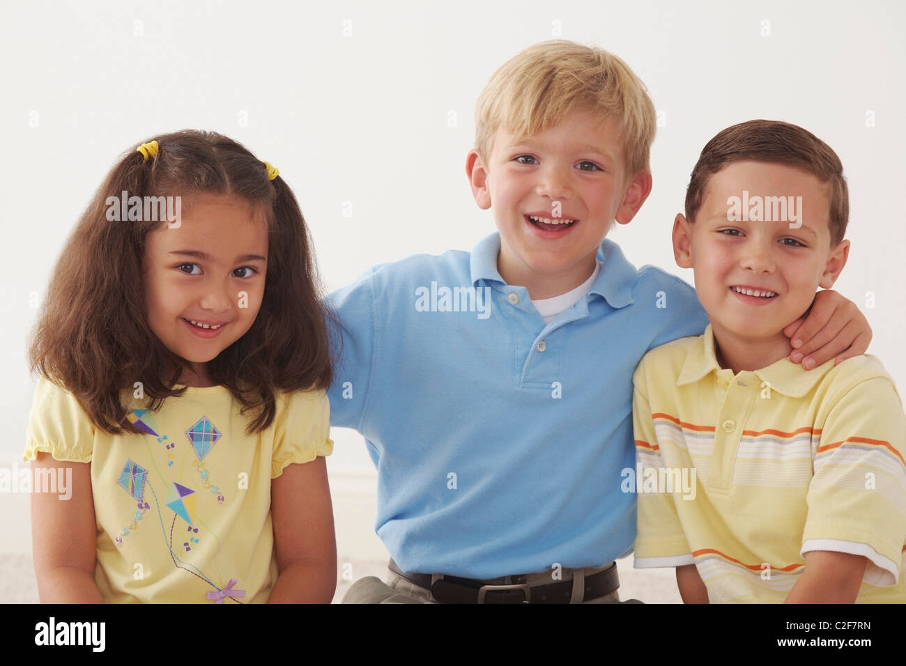 Three Children In An Embrace Stock Photo - Alamy