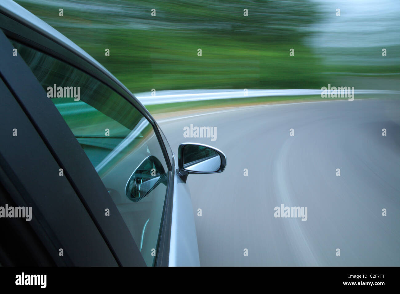 car driving fast into forest Stock Photo - Alamy