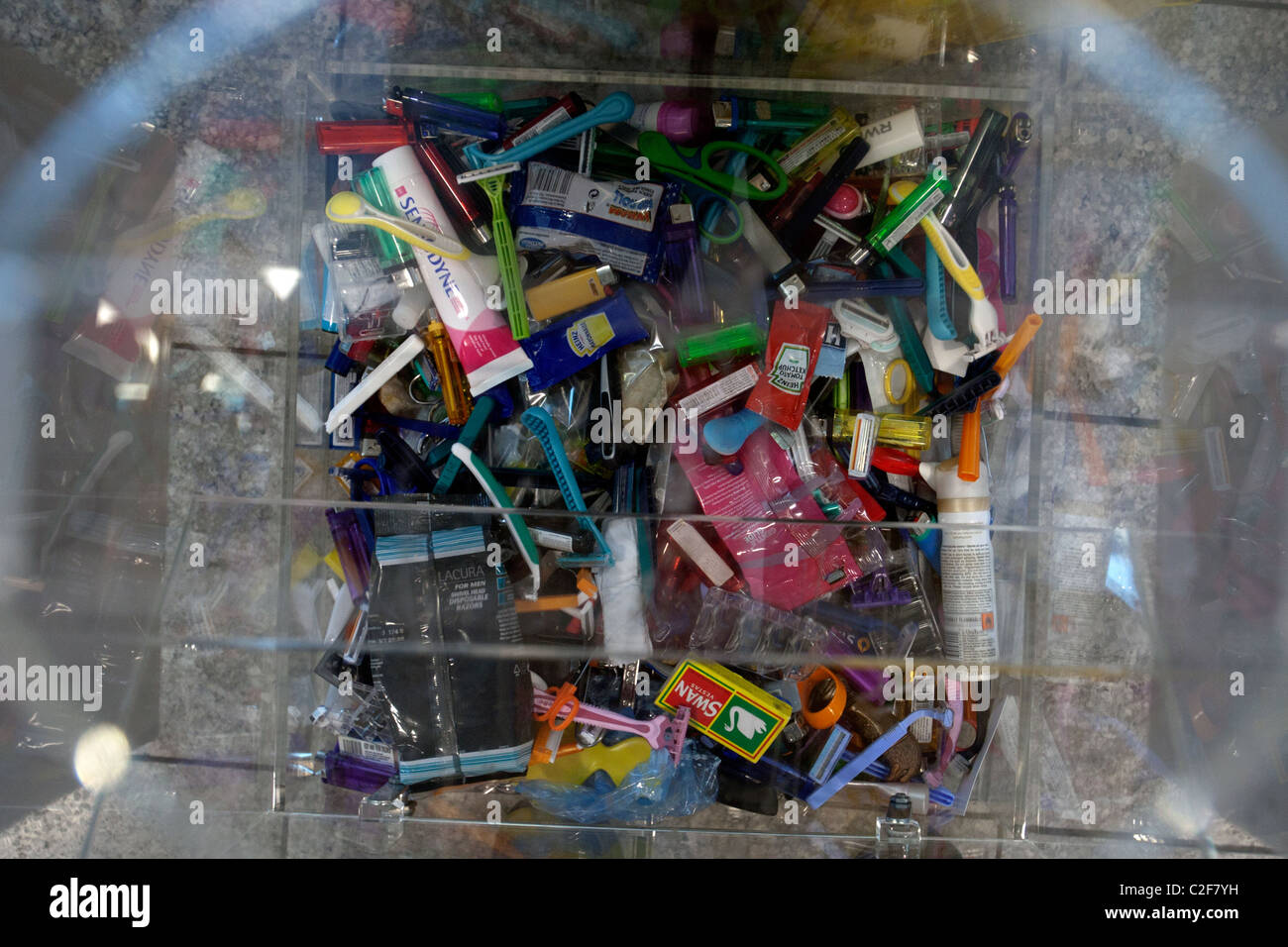 discarded items in an airport bin at security area Stock Photo - Alamy