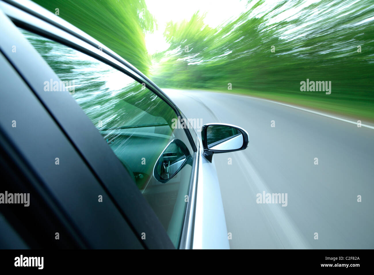 car driving fast into forest Stock Photo - Alamy