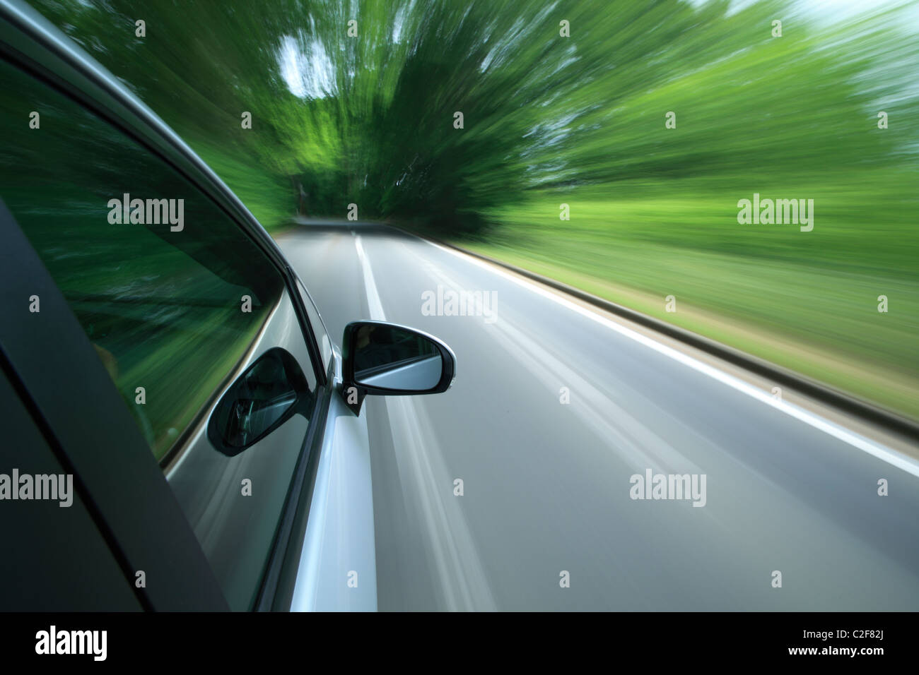 car driving fast into forest Stock Photo - Alamy