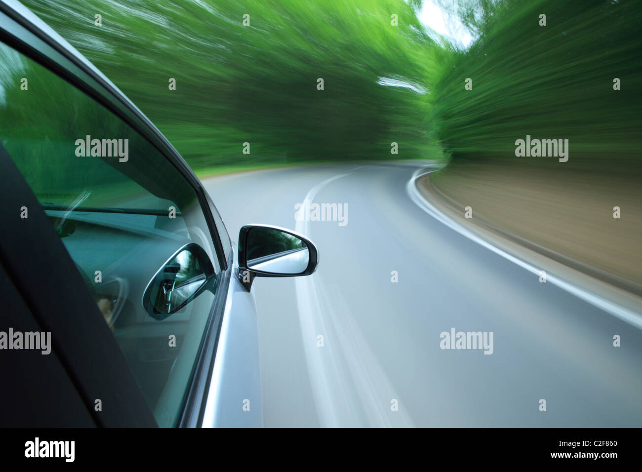 car driving fast into forest Stock Photo - Alamy