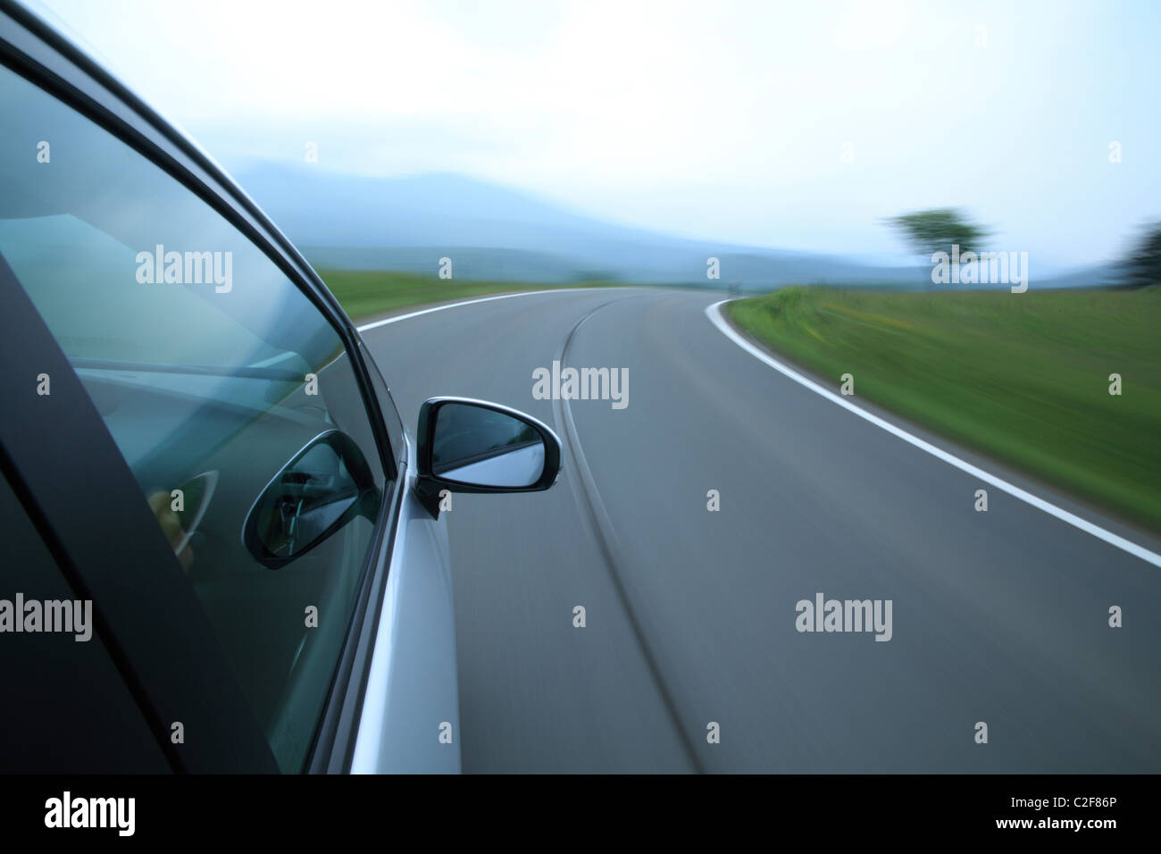 car driving fast into forest Stock Photo - Alamy