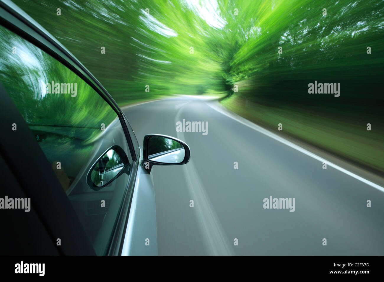 car driving fast into forest Stock Photo - Alamy