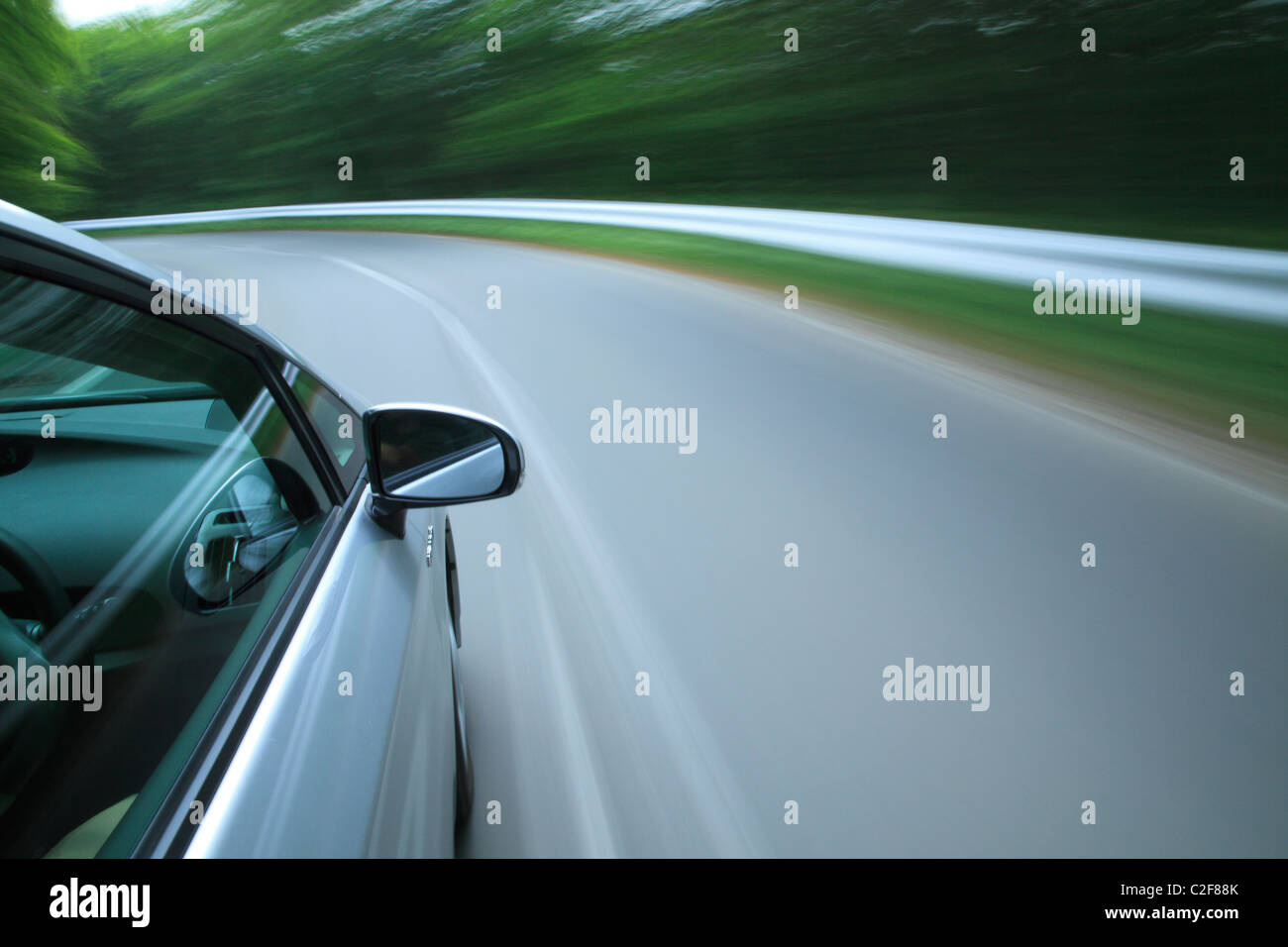 car driving fast into forest Stock Photo - Alamy