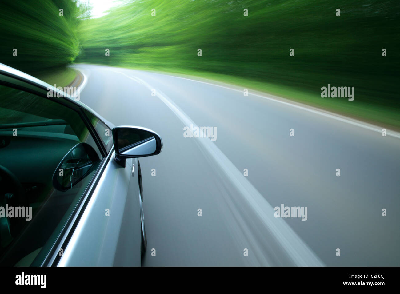 car driving fast into forest Stock Photo - Alamy