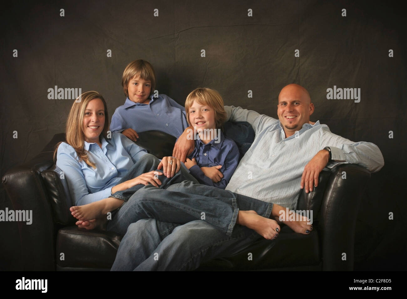 Portrait Of A Family On A Couch Stock Photo - Alamy