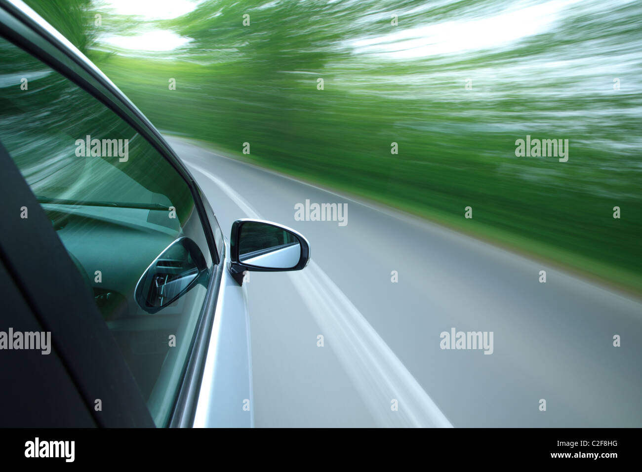 car driving fast into forest Stock Photo - Alamy