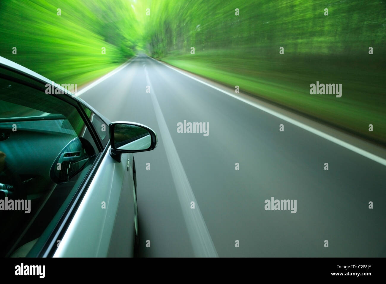car driving fast into forest Stock Photo - Alamy