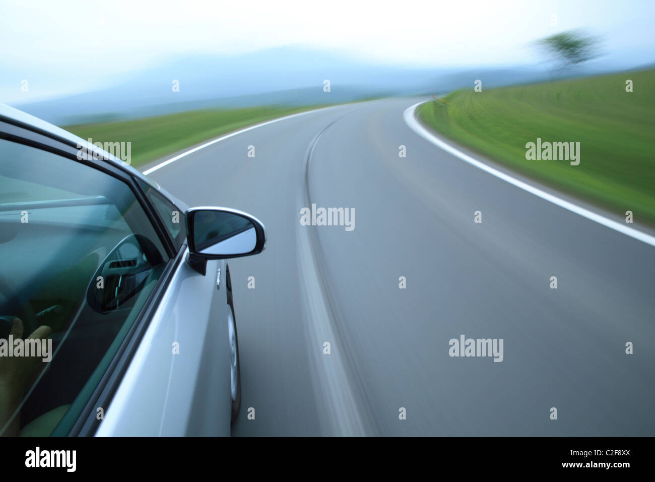 car driving fast into forest Stock Photo - Alamy