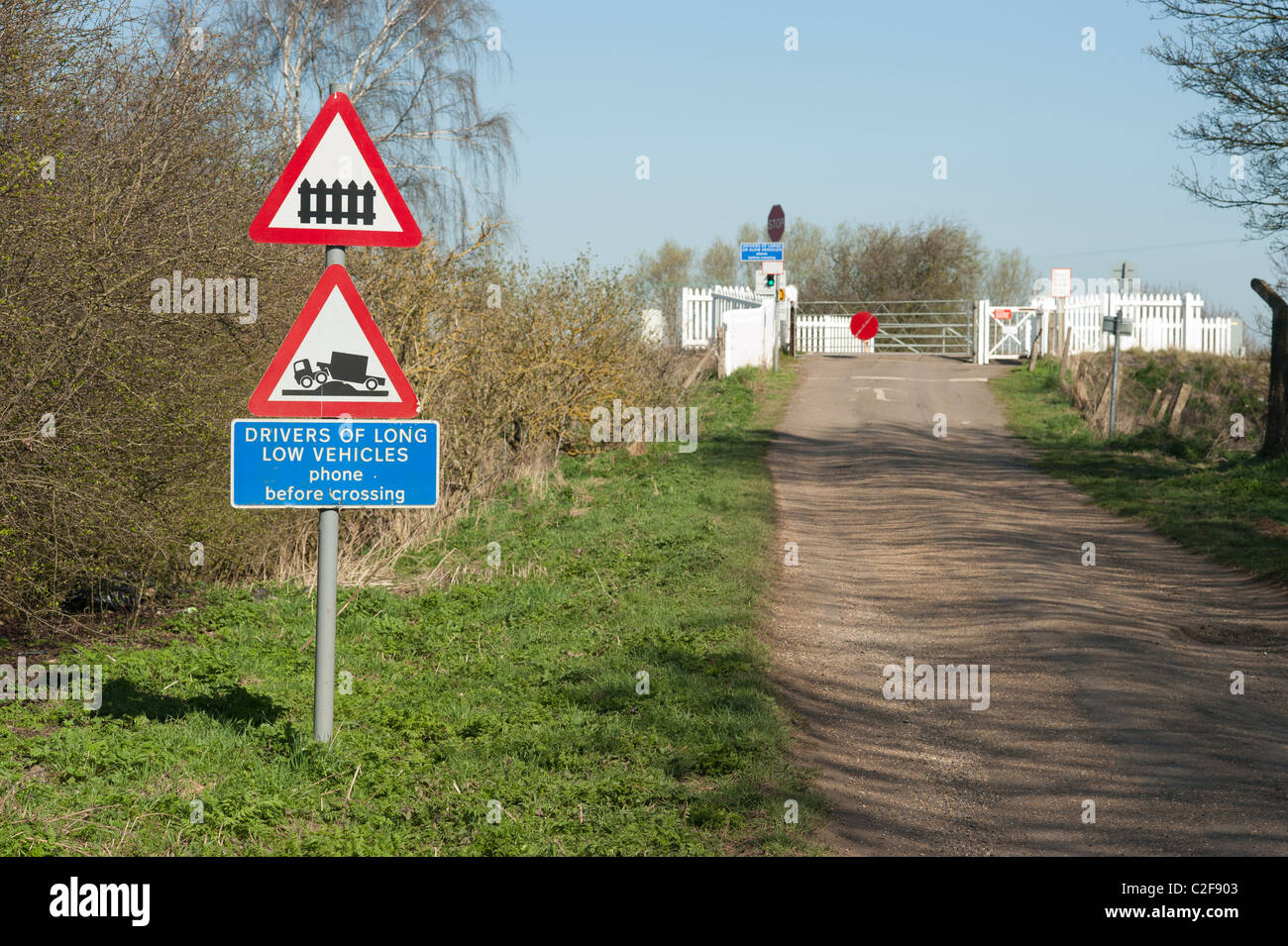 Complex warning signs at a railroad crossing in England Stock Photo - Alamy