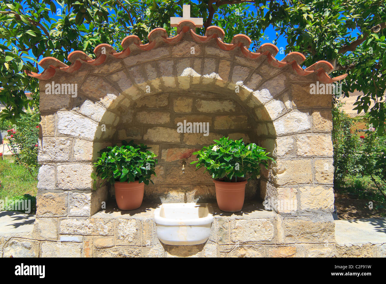Flower-decorated faucet in Greek monastery Stock Photo - Alamy