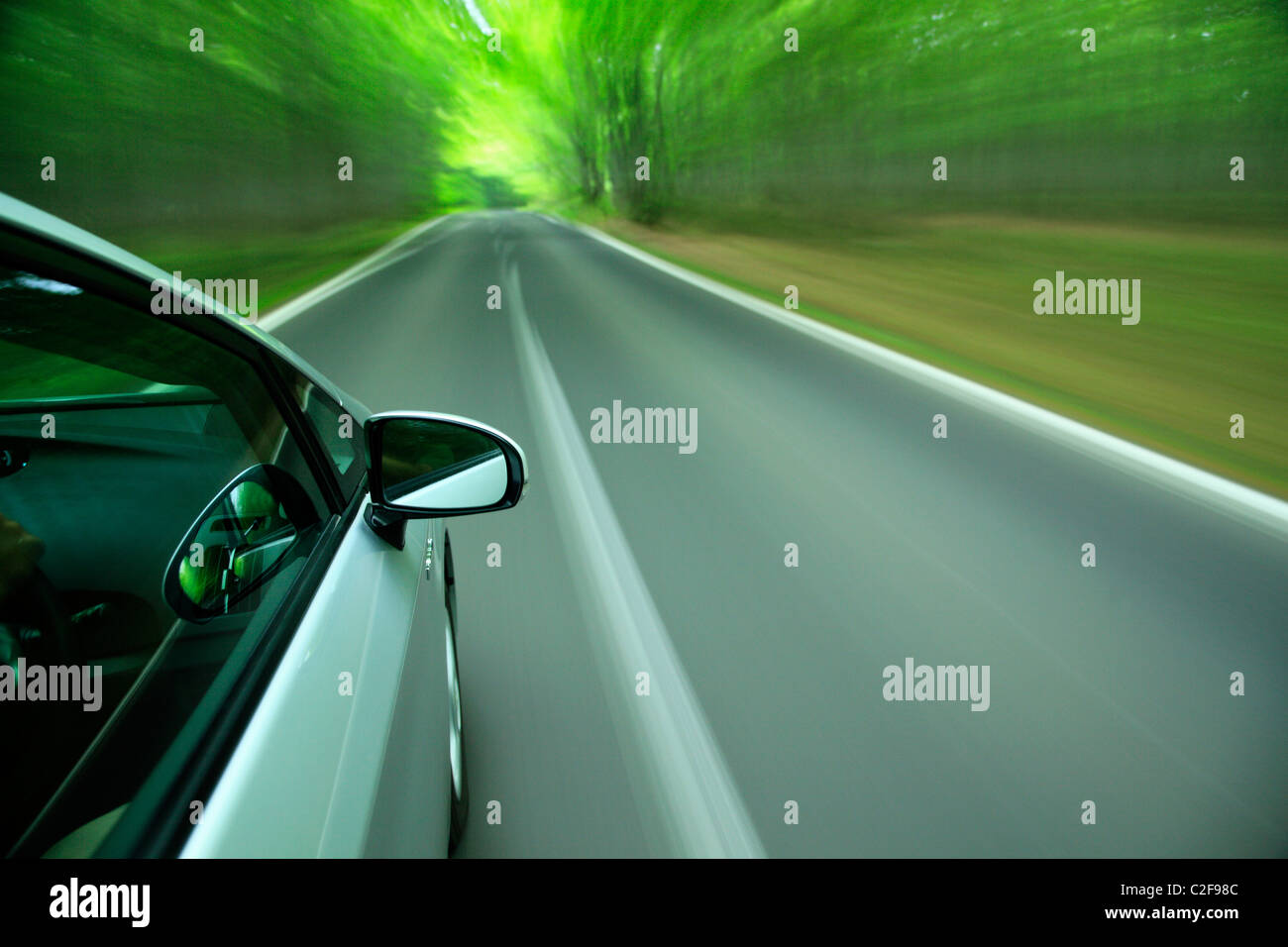 car driving fast into forest Stock Photo - Alamy