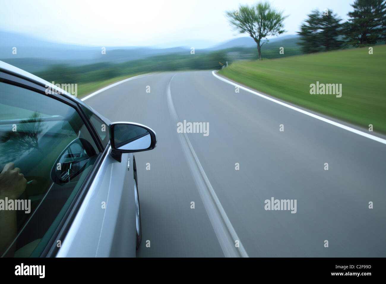 car driving fast into forest Stock Photo - Alamy