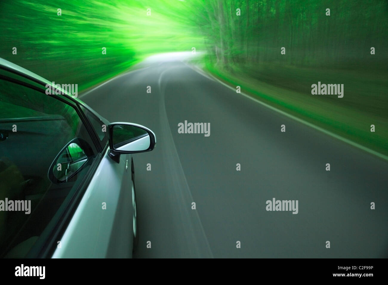 car driving fast into forest Stock Photo - Alamy