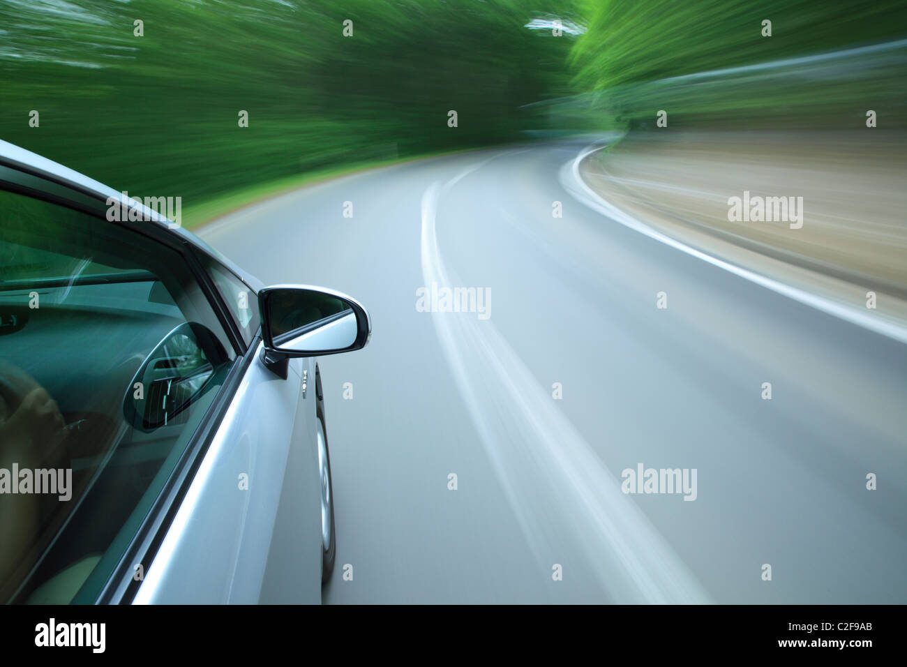 car driving fast into forest Stock Photo - Alamy