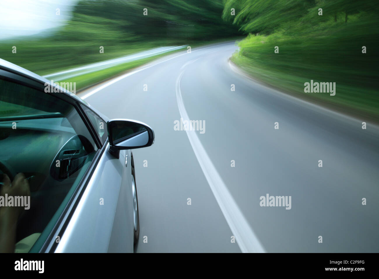 car driving fast into forest Stock Photo - Alamy