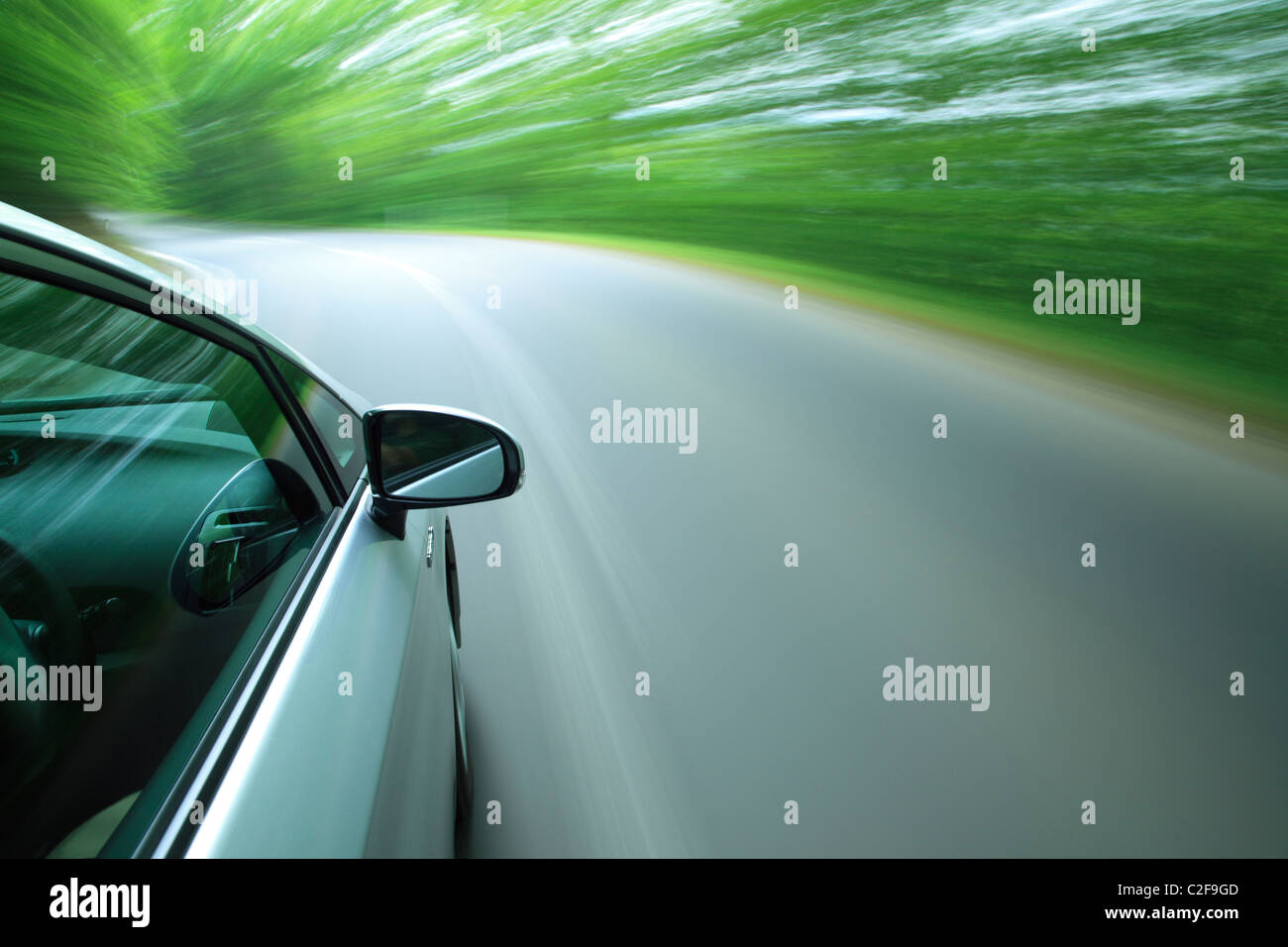 car driving fast into forest Stock Photo - Alamy